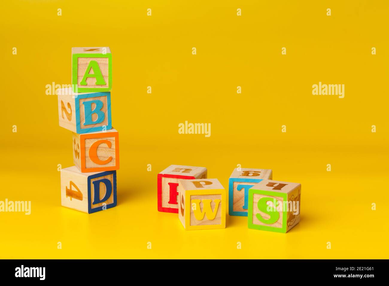 Colorful wooden blocks with letters on a yellow color background Stock ...