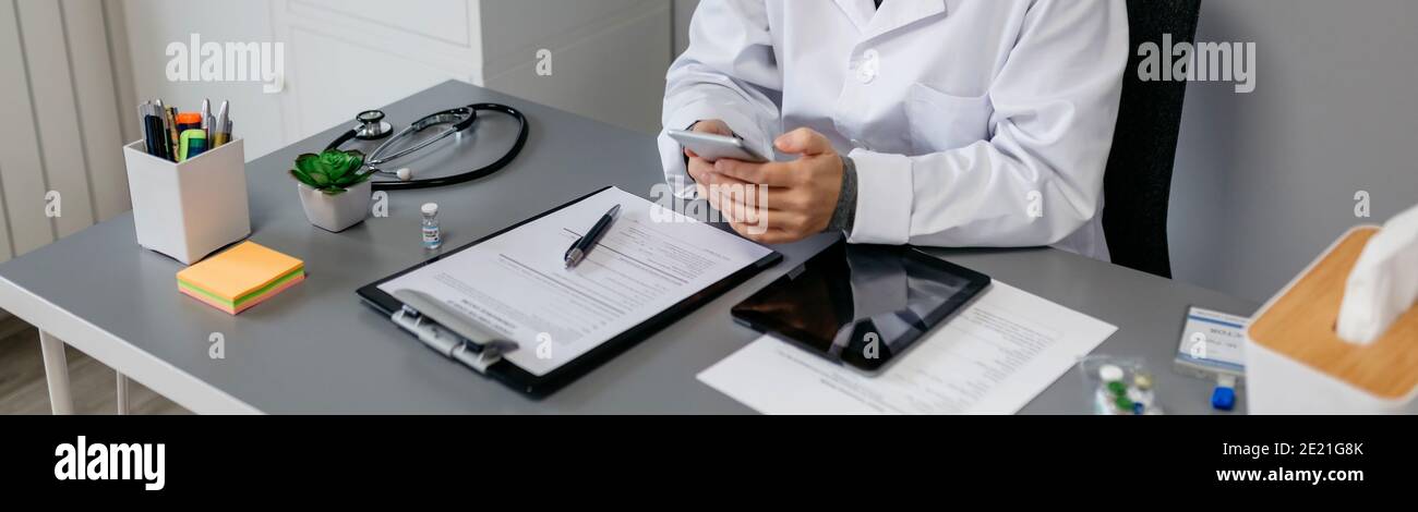 Female doctor using mobile while working Stock Photo - Alamy