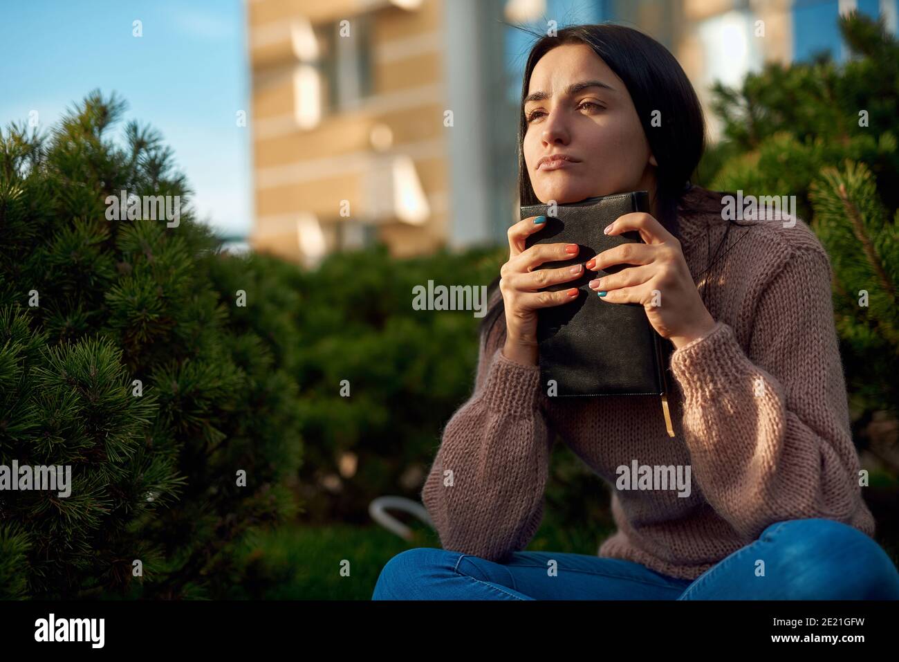 Brooding and serious young woman thinking about something important ...