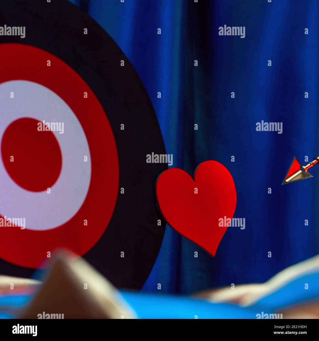 Small golden cupid marks his target with an arrow at the heart ...