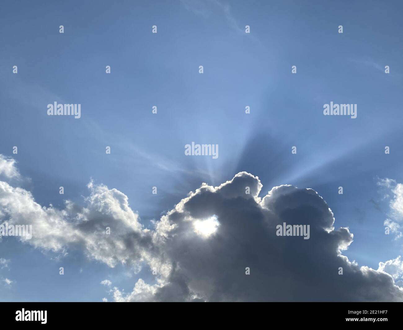 Bright sun with dramatic sunlight shining through a rainy cloud Stock ...