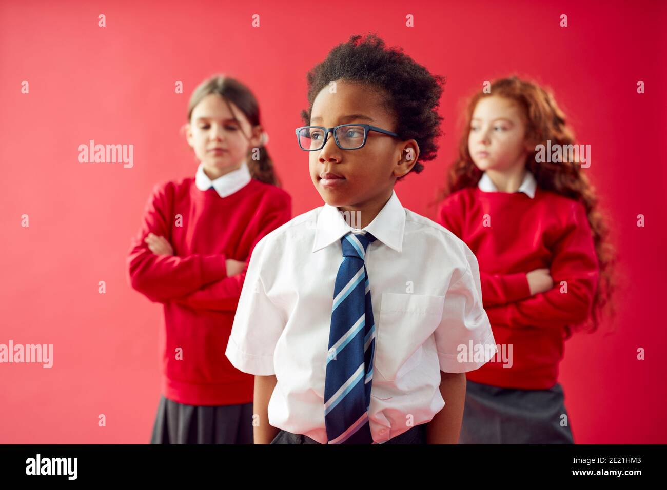 Group Of Elementary School Pupils Wearing Uniform Folding Arms Against ...