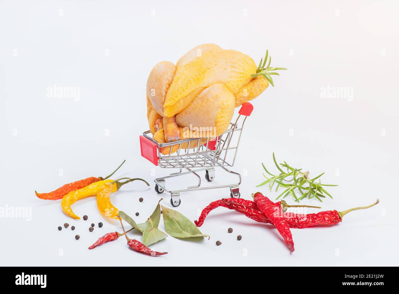 Fresh raw chicken in a basket.A whole chicken in a supermarket trolley ...