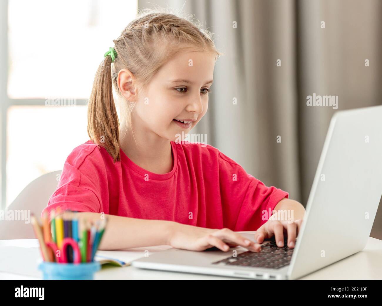 Little girl talking online using laptop Stock Photo - Alamy