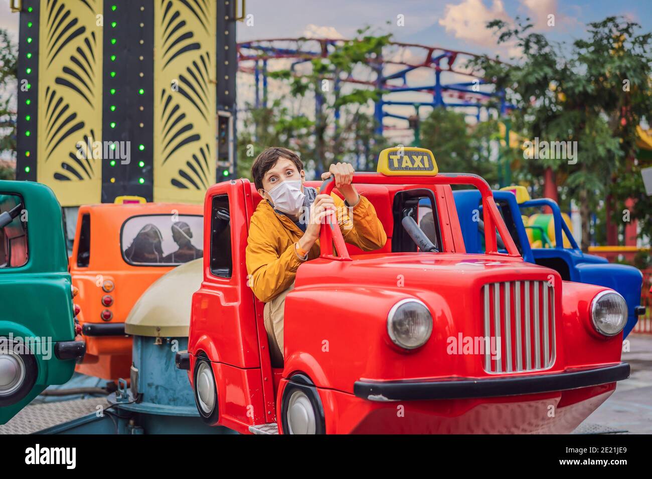 Man riding a carousel wearing a medical mask during COVID-19 ...