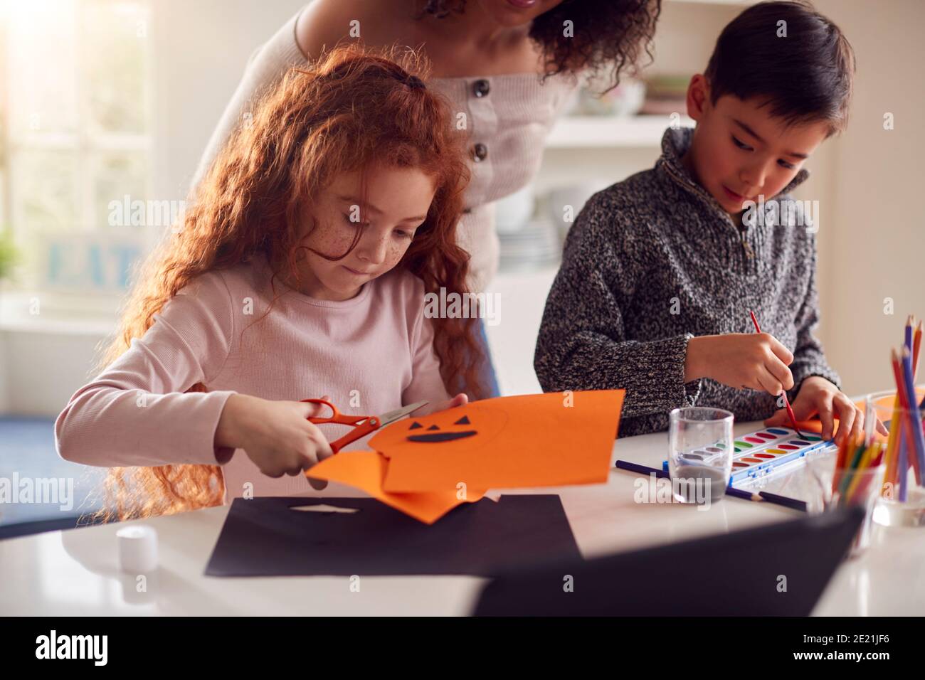 Group Of Children At Home With Mother Having Fun Making Craft Together ...