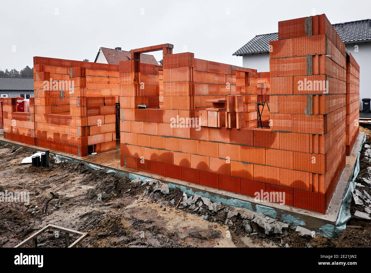 Construction site with the beginning of a shell of brick concrete ...