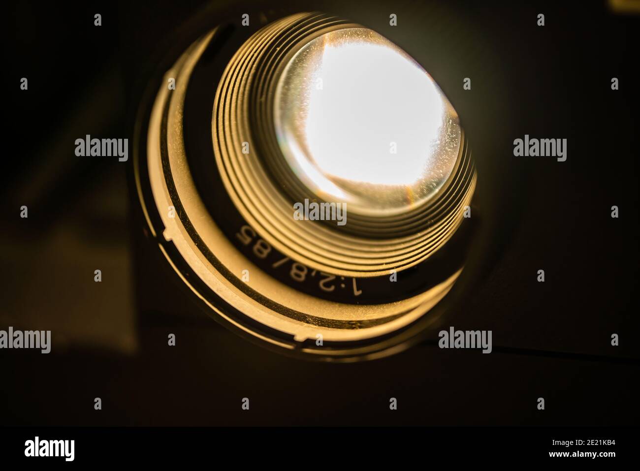 Close up image of a vintage film and slide projector lens on a dark ...