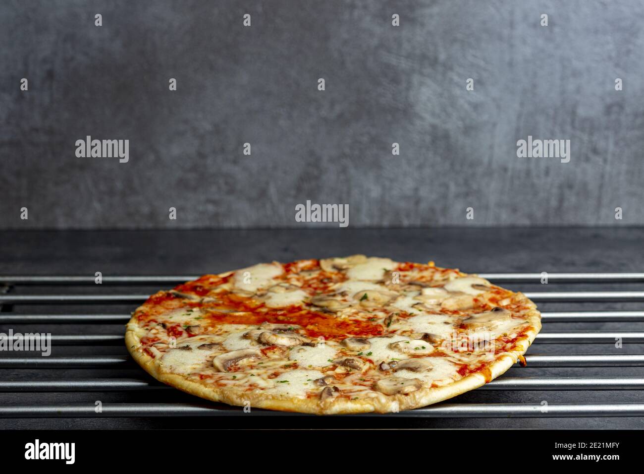 Fresh pizza in modern gray kitchen Stock Photo - Alamy