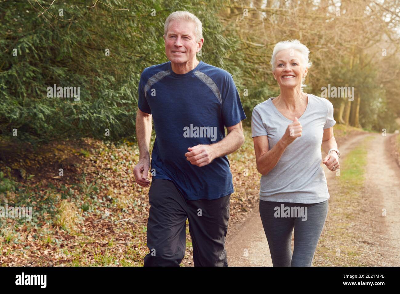 Senior Couple Exercising In Autumn Countryside During Covid 19 Lockdown ...