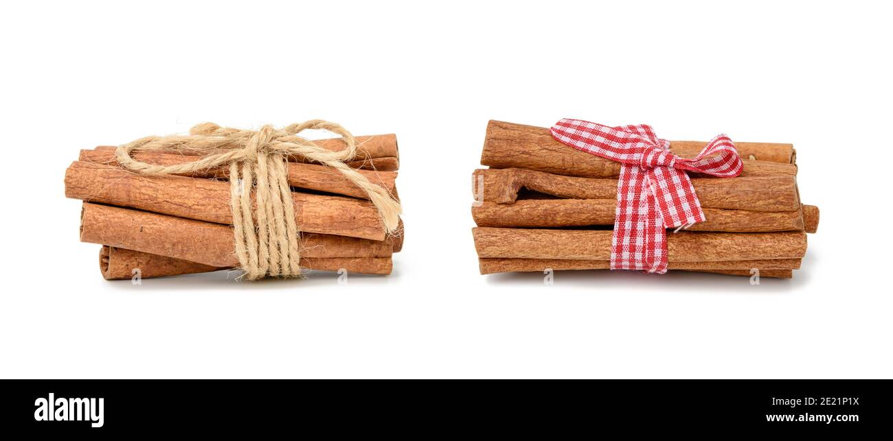 dry cinnamon sticks tied with red ribbon, spice isolated on white ...