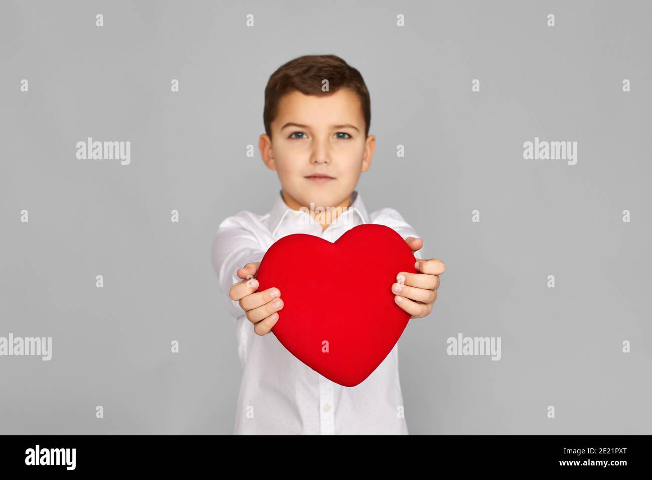 valentine's day. cute little child boy holding red heart isolated on ...