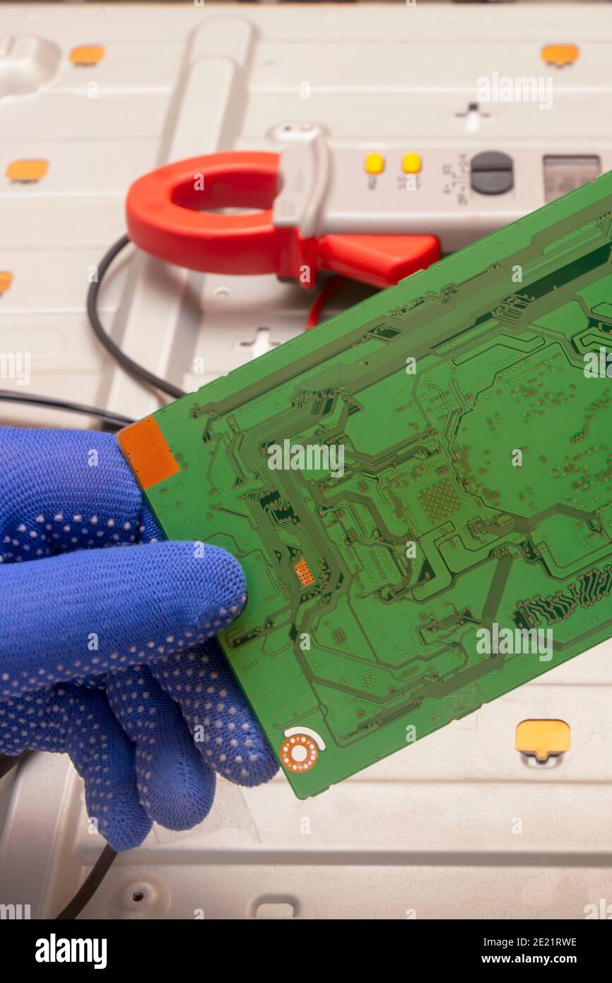 Green LCD TV PCB for diagnostics at service center. Close-up, selective ...