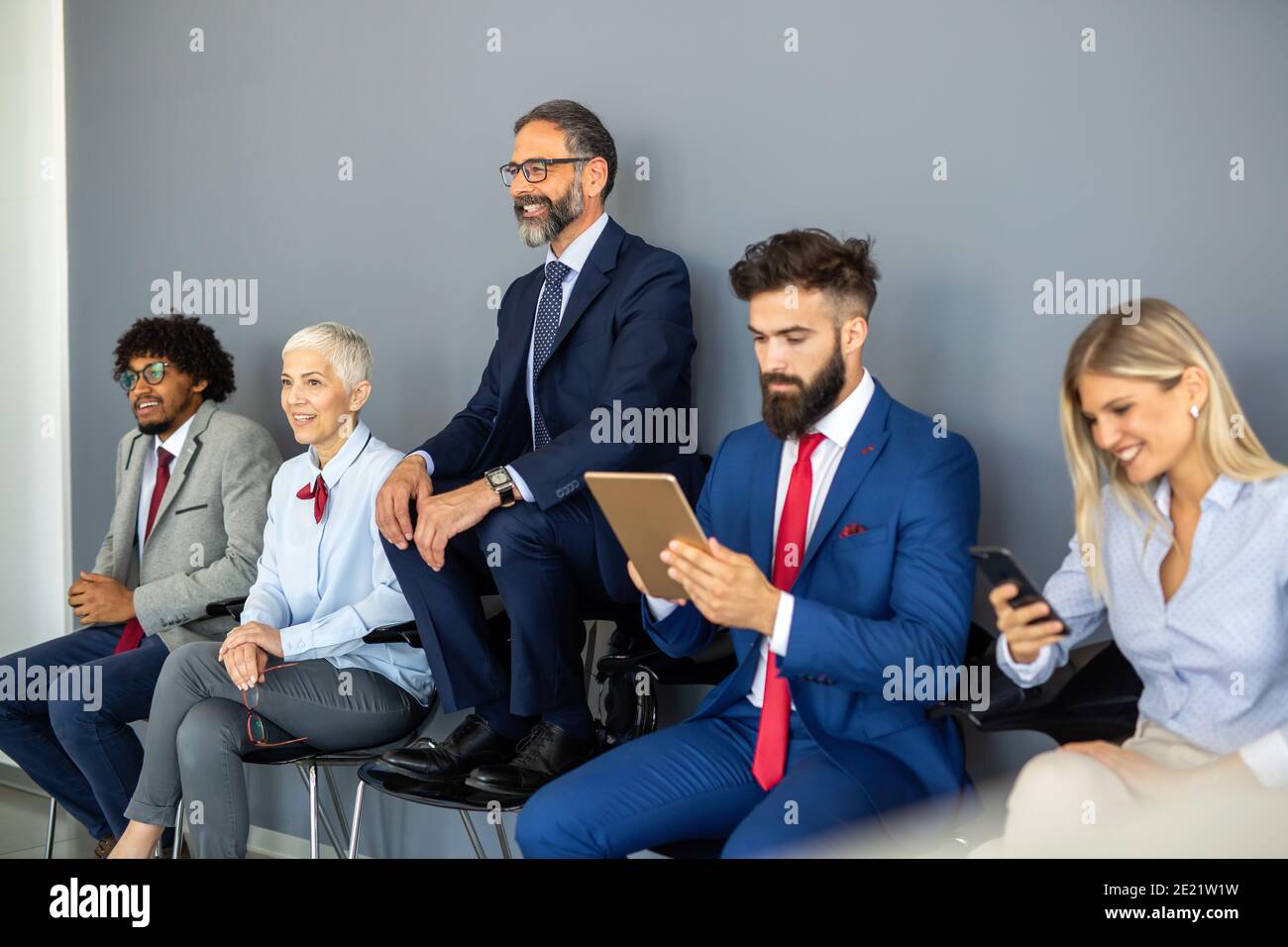 Group of friendly businesspeople with male leader in front Stock Photo ...