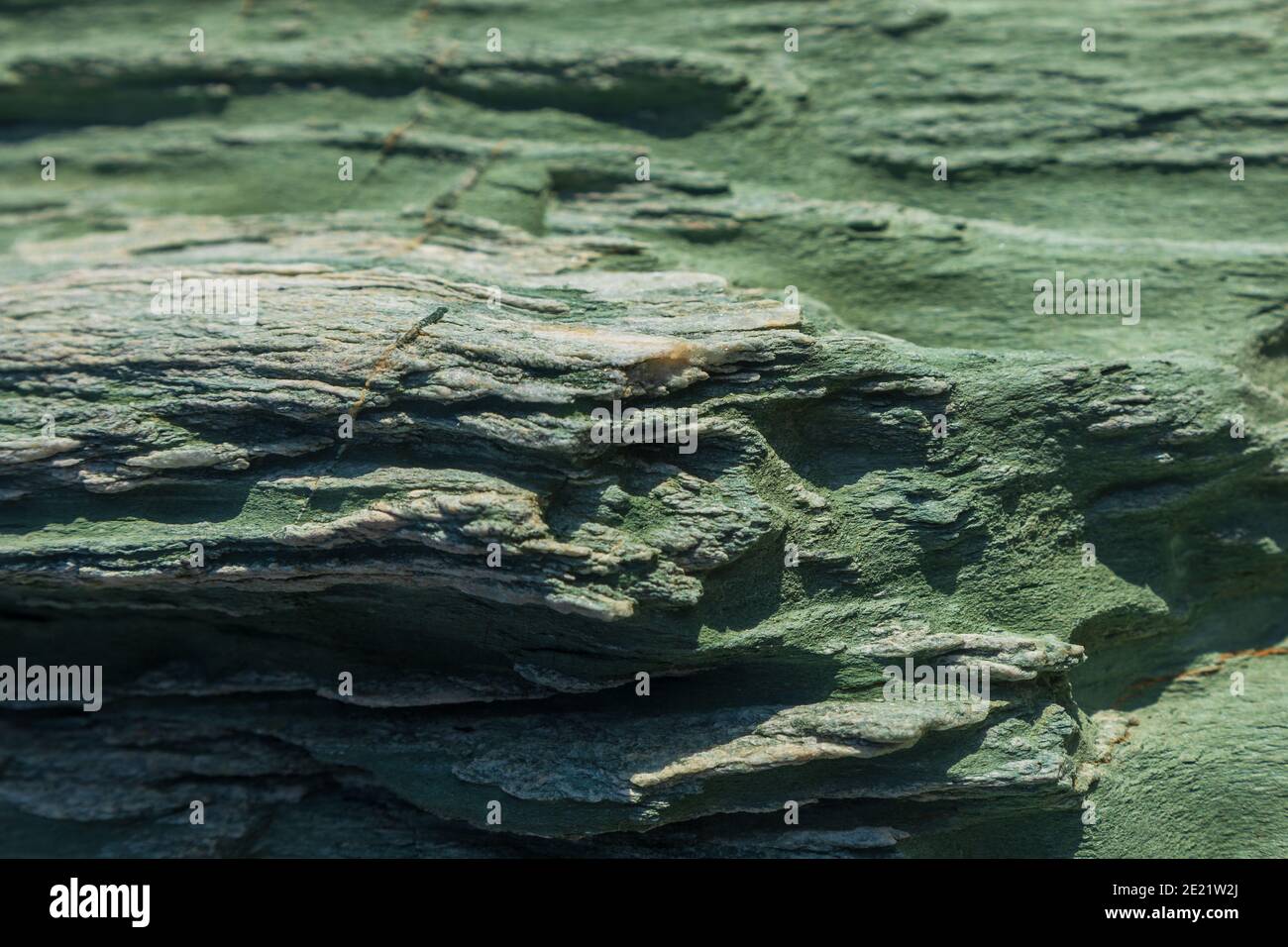 Turquoise green rock, background texture, natural stone off the coast ...