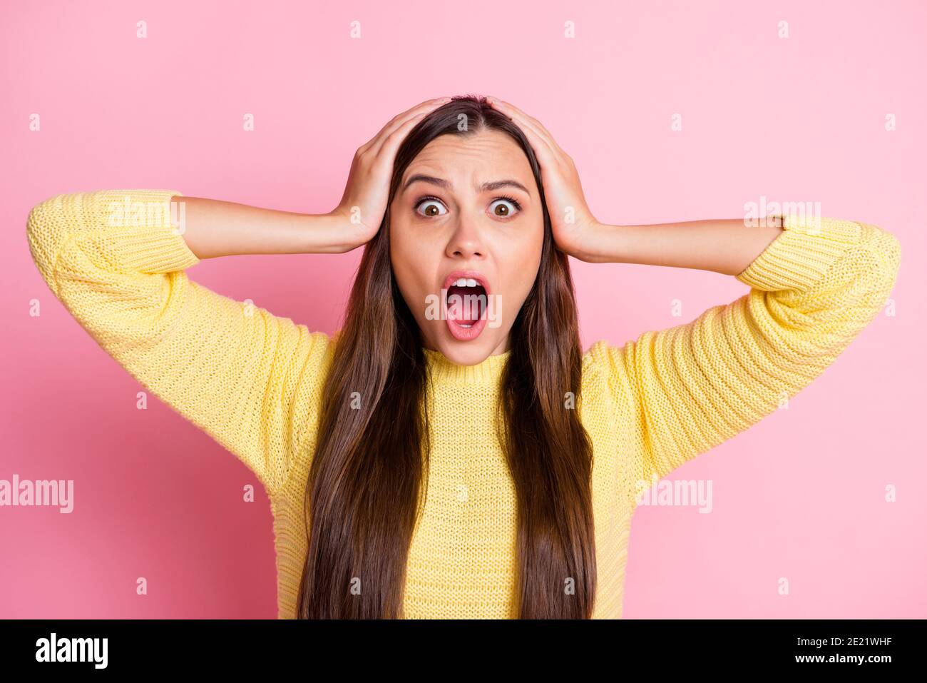 Portrait Of Young Attractive Shocked Surprised Scared Afraid Girl Hold