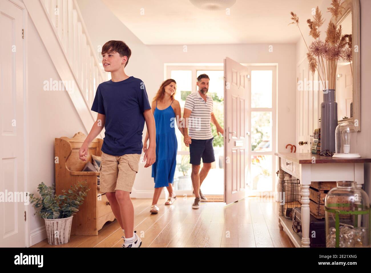 Women boy coming out house hi-res stock photography and images - Alamy