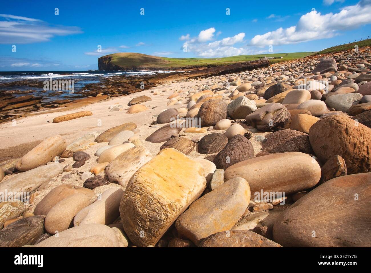 Big round stones on west shoreline of Orkney islands on summer sunny ...