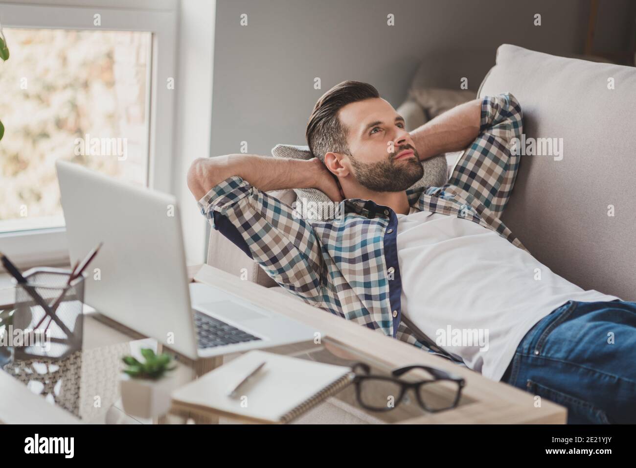 Photo of young handsome man work remote finish task break pause relax ...