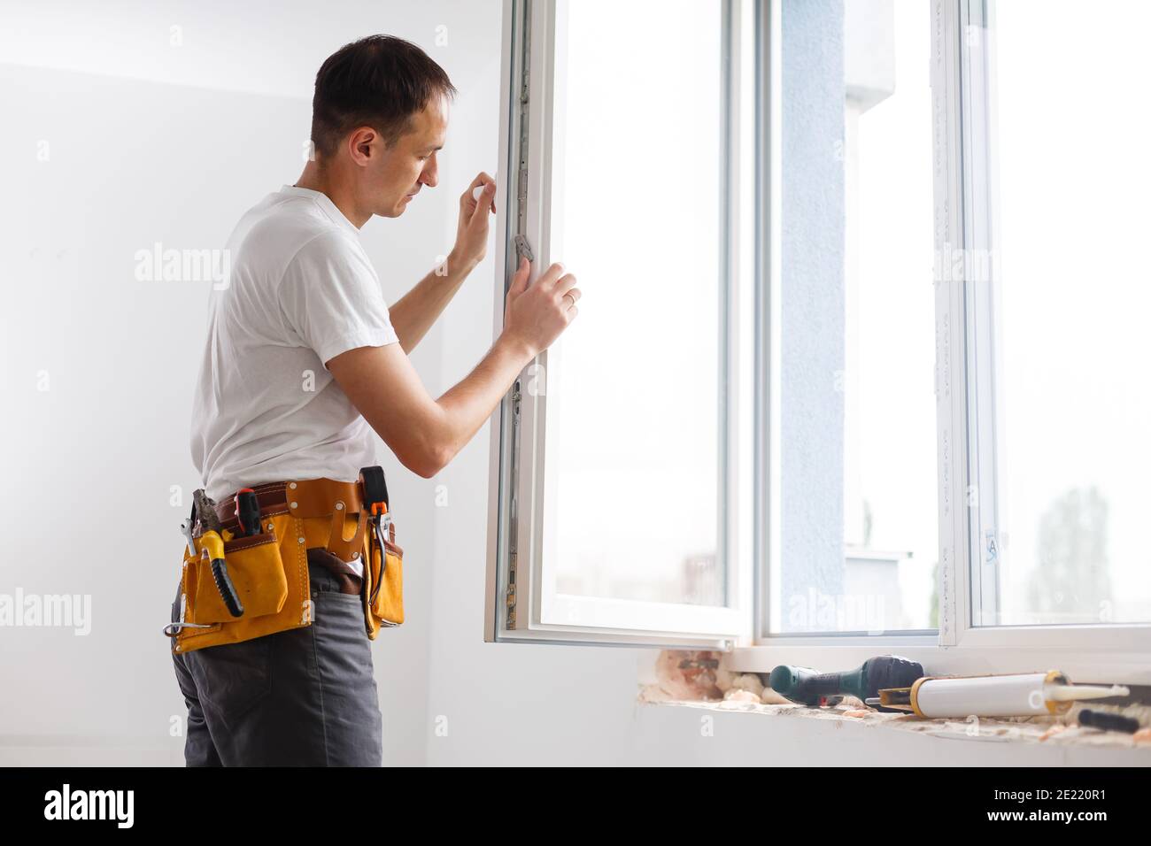 male industrial builder worker at window installation in building ...