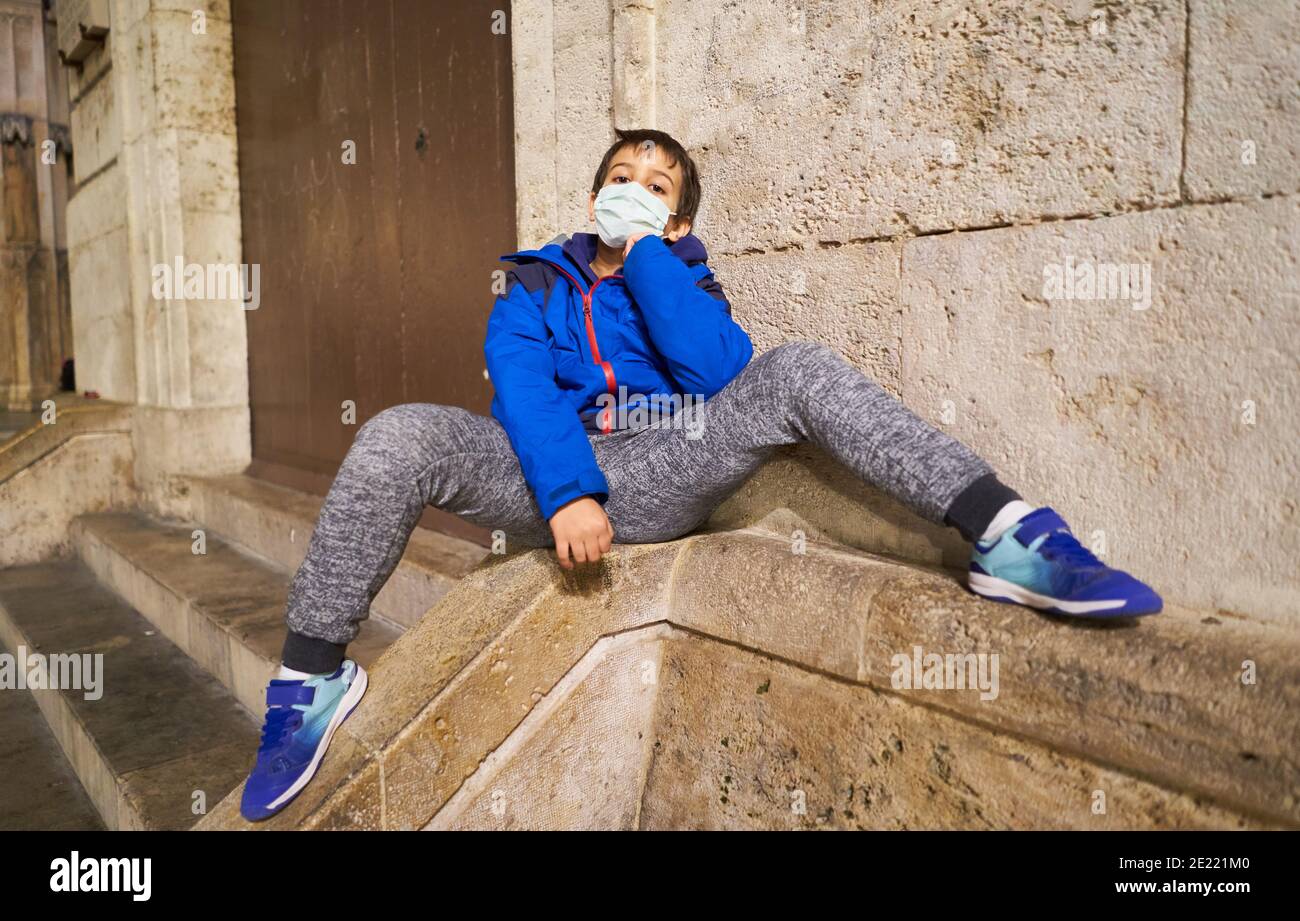 Cute Caucasian boy wearing a mask, posing on the background of an ...