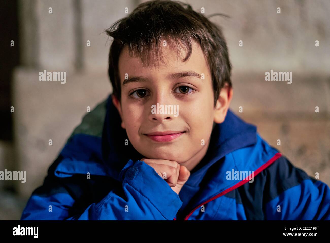 Cute Caucasian boy wearing a jacket and happily posing Stock Photo - Alamy
