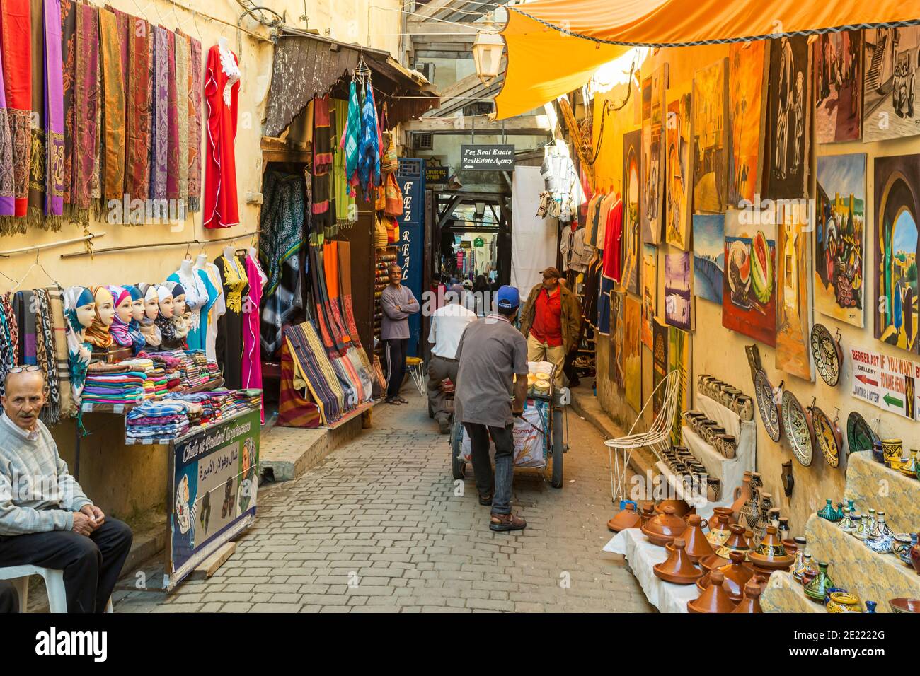 Several gentlemen pushing carts through the Medina of Fez, Morocco ...