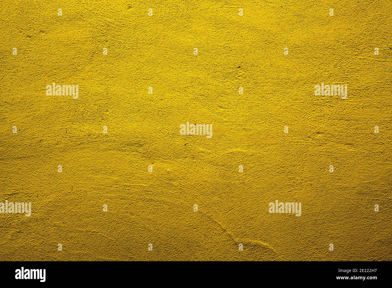 Yellow colored abstract wall background with textures of different ...