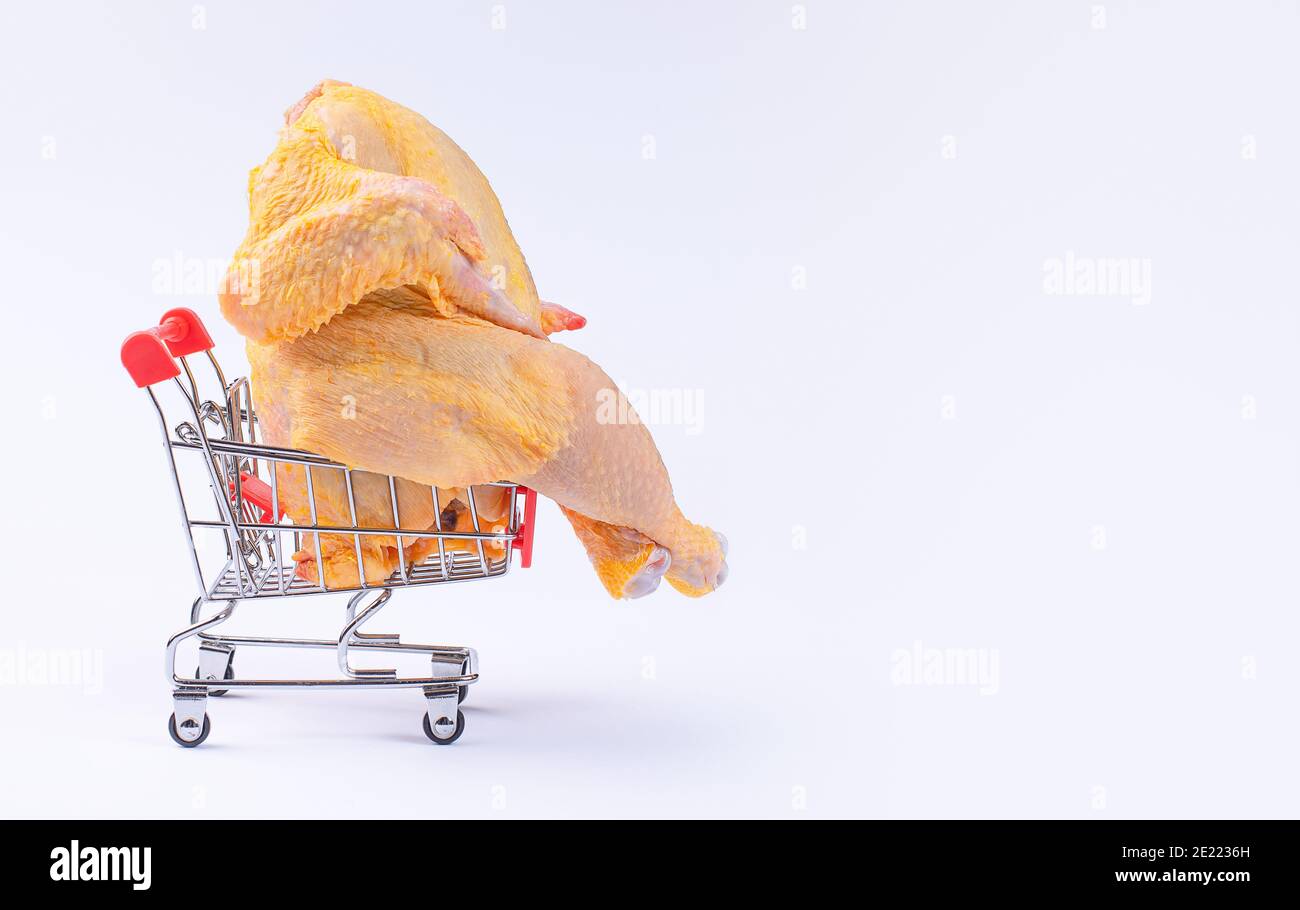 Fresh raw chicken in a basket.A whole chicken in a supermarket trolley ...