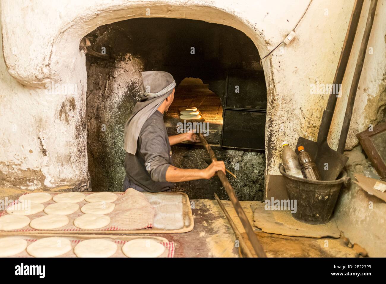 Baker baking Morocco small flat loaves known as khobz. Every ...