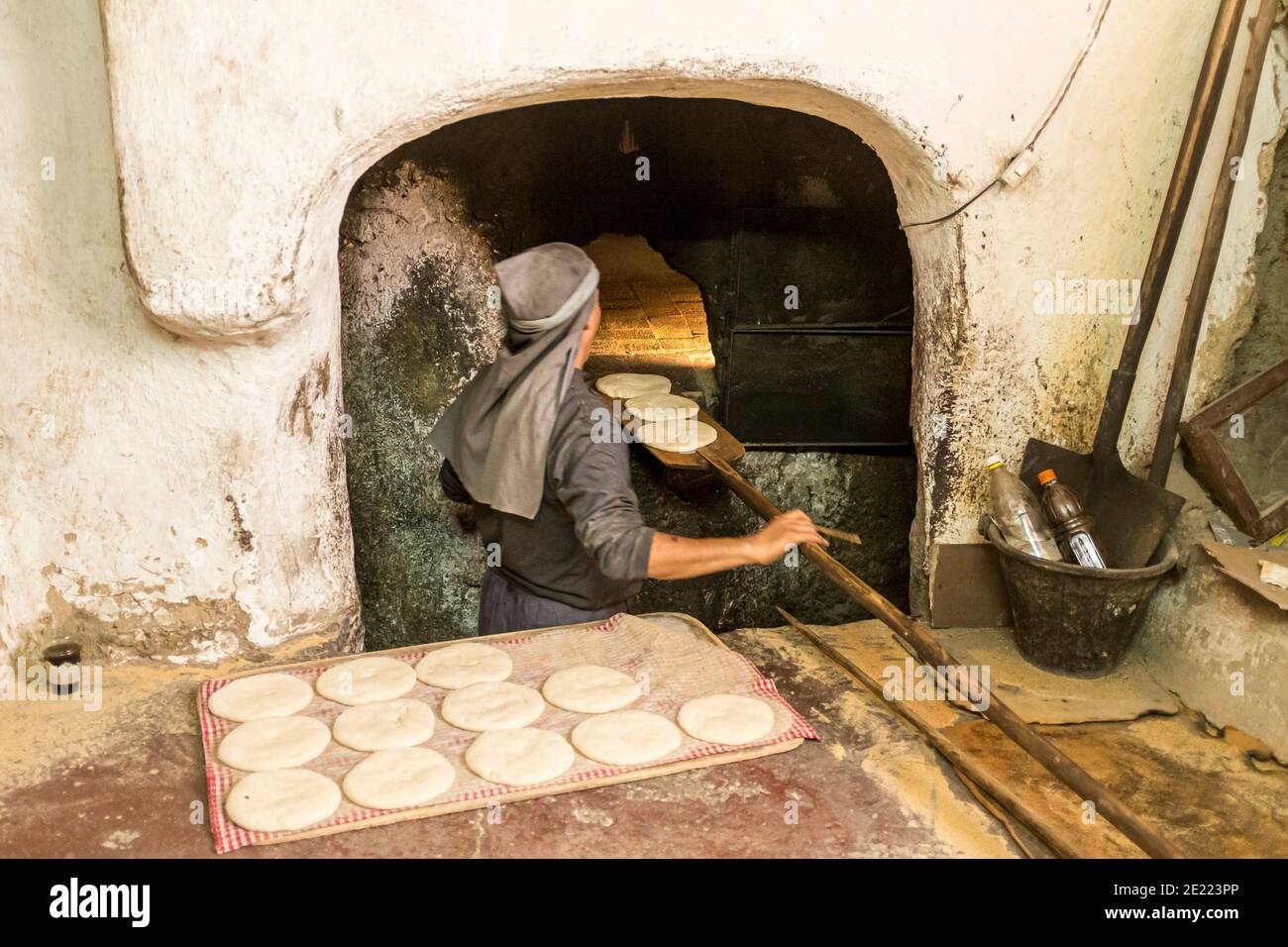 Baker baking Morocco small flat loaves known as khobz. Every ...