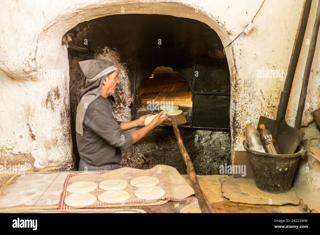 Baker baking Morocco small flat loaves known as khobz. Every ...