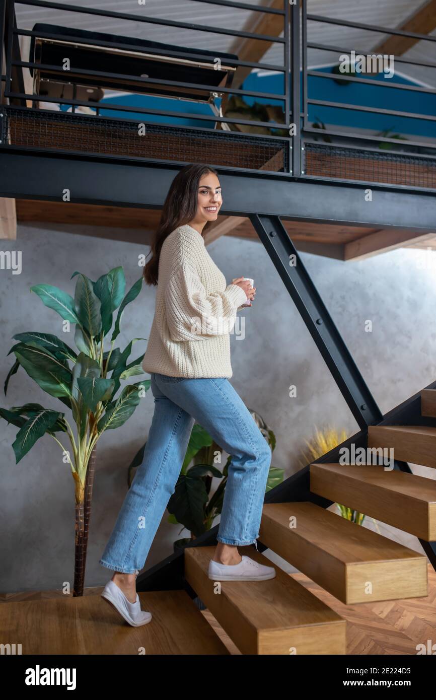 Woman going upstairs hi-res stock photography and images - Alamy