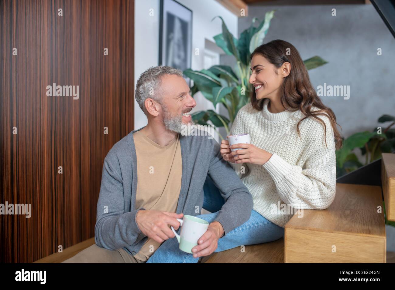 Married couple having coffee together and talking Stock Photo - Alamy
