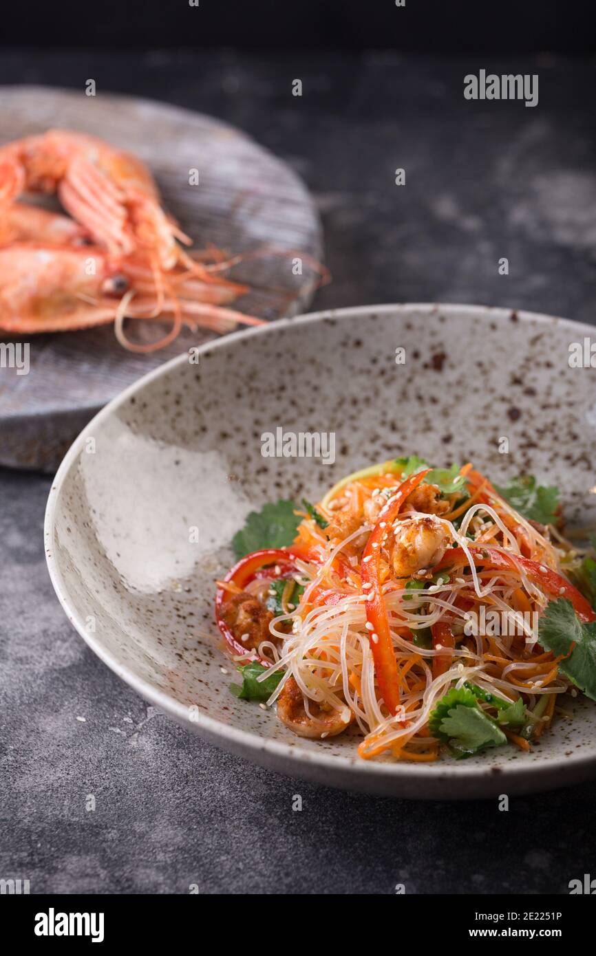 Funchose salad with shrimps and vegetables with sesame seeds. Photo for ...