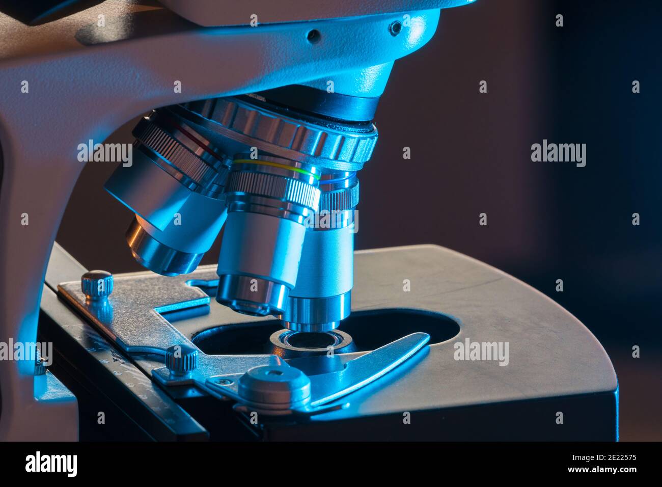 Microscope in laboratory at night in blue light. Microbiology and ...