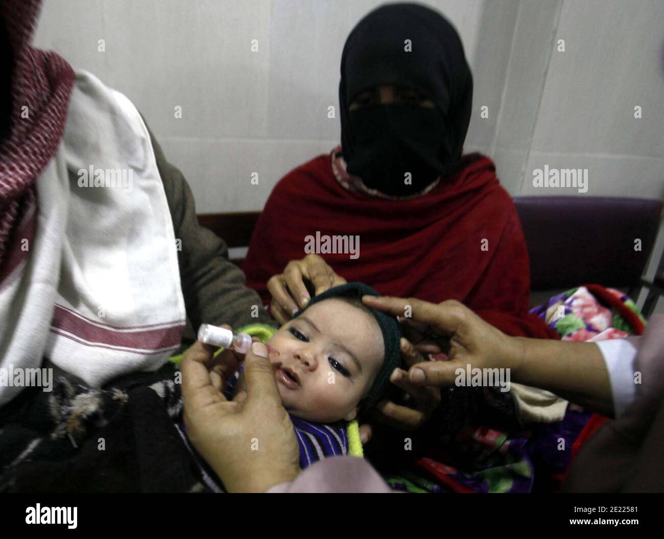 Health worker administrates polio-vaccine drops to a child during anti ...