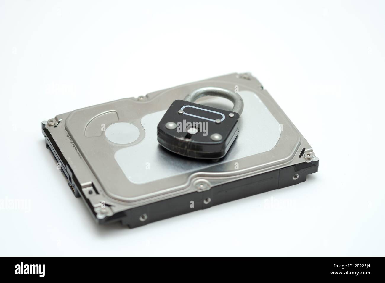 Computer hard disk and metal padlock symbolizing concept for encrypted ...