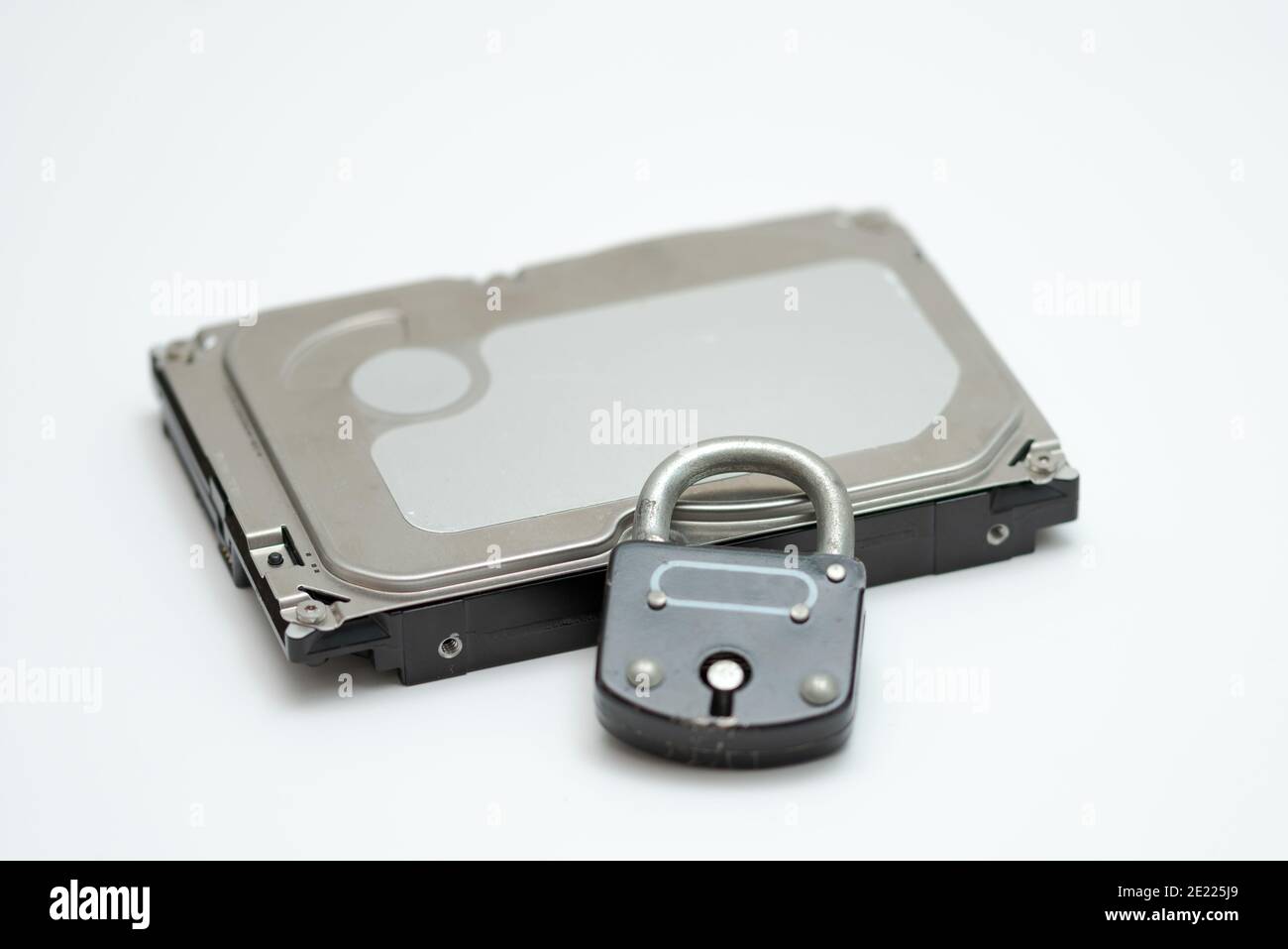 Computer hard disk and metal padlock symbolizing concept for encrypted ...