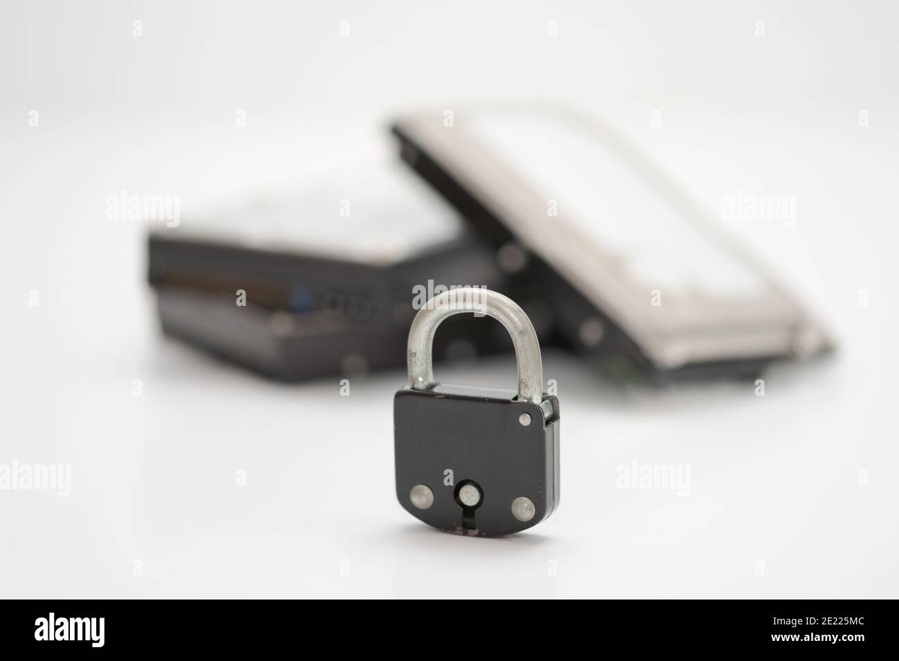 Computer hard disks and metal padlock symbolizing concept for encrypted ...