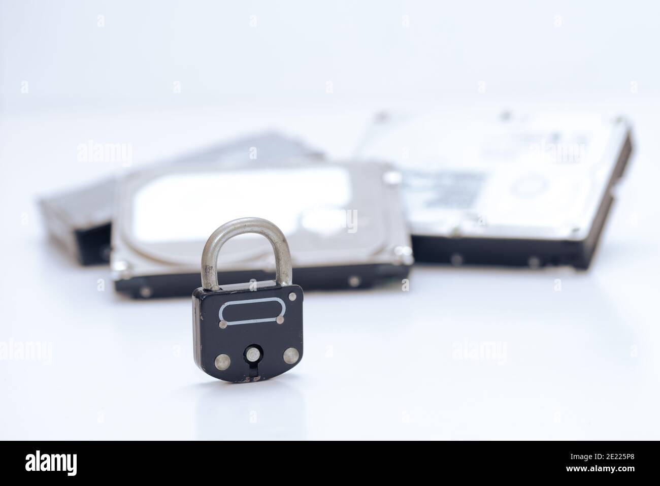 Computer hard disks and metal padlock symbolizing concept for encrypted ...