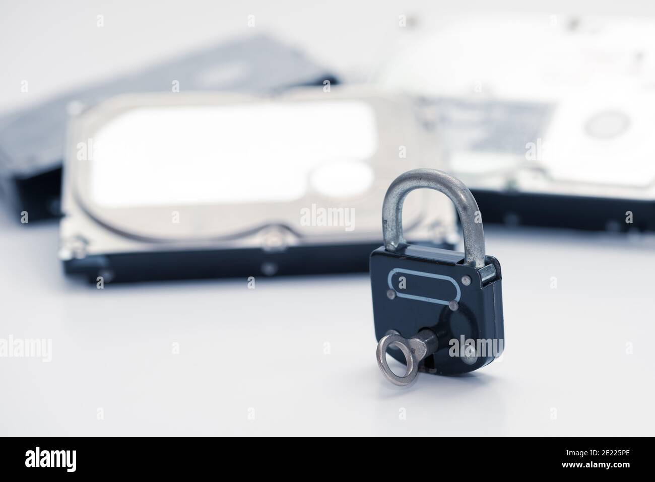 Computer hard disks and metal padlock with key symbolizing concept for ...