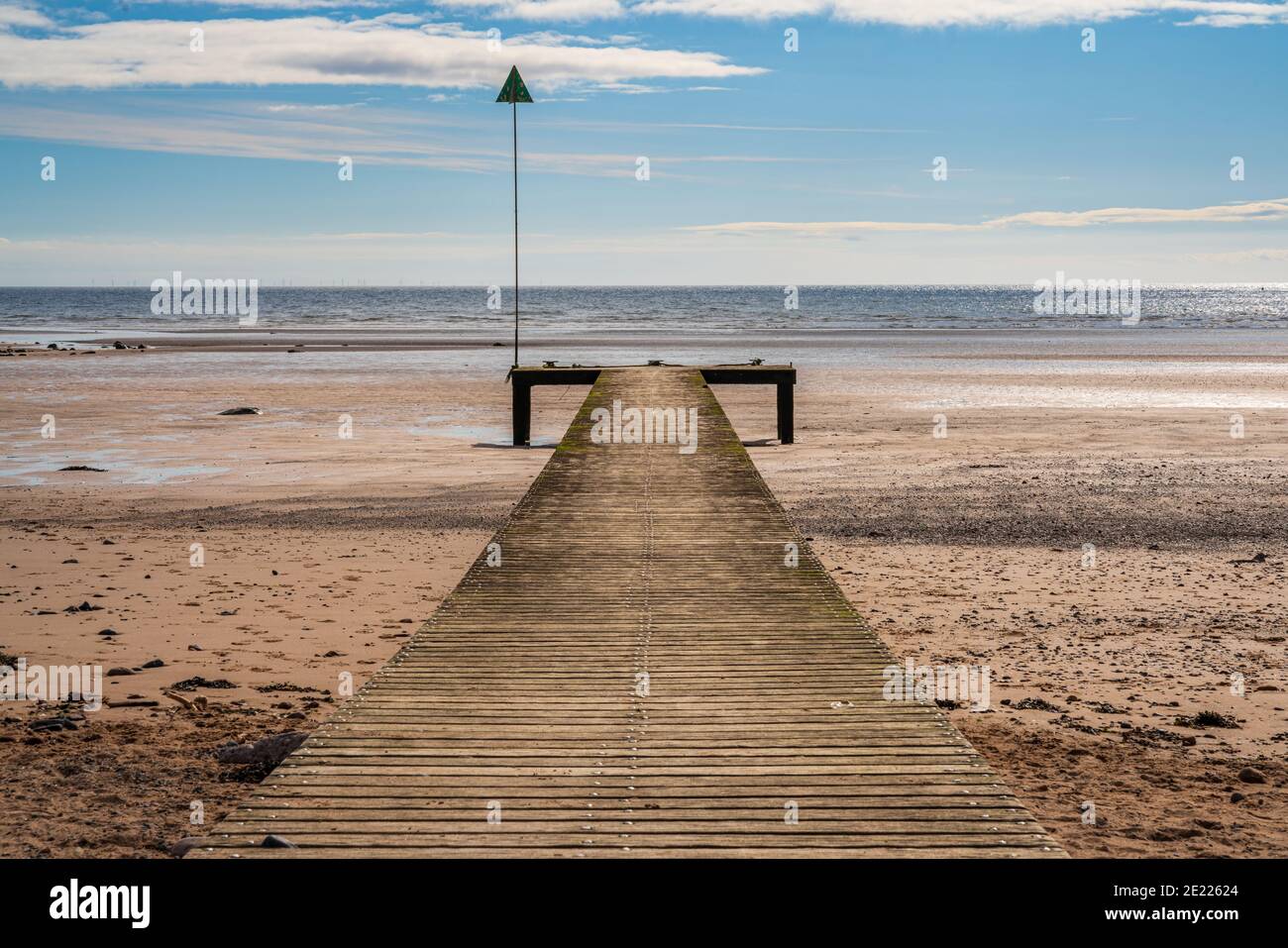 The beach and a wooden walkway in Seascale, Cumbria, England, UK Stock ...