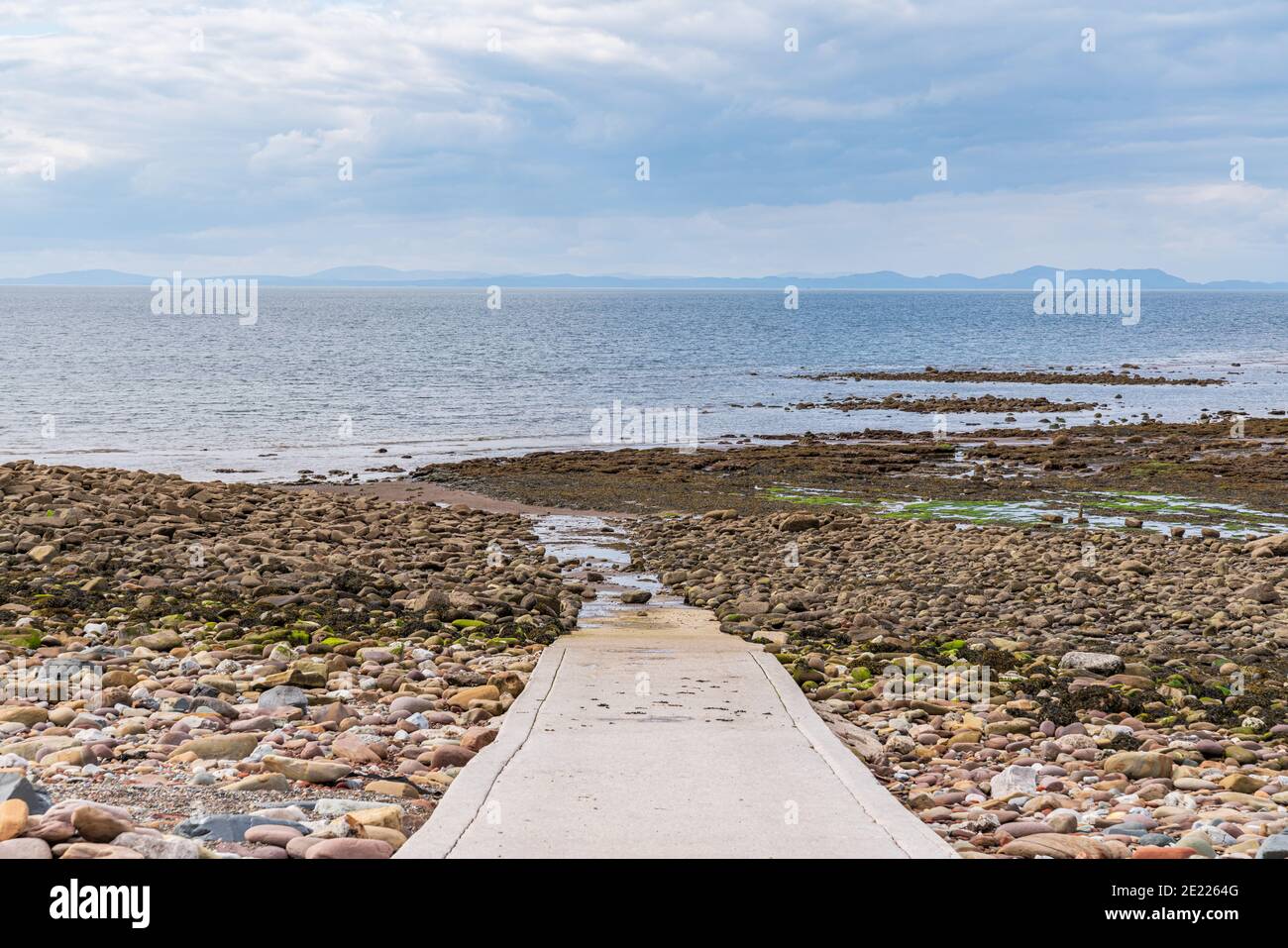 Public Slipway with stones in the low tide on Parton Beach, Cumbria ...