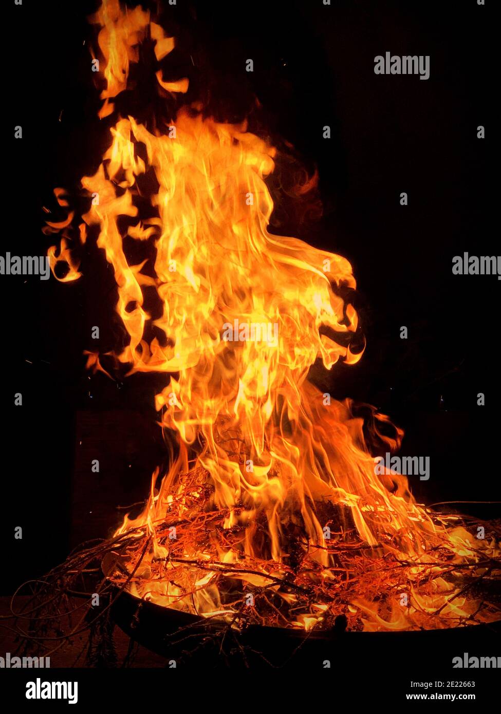 Vertical shot of fire flames in the dark Stock Photo - Alamy