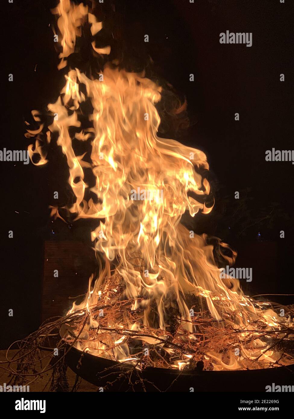 Vertical shot of fire burning in the dar Stock Photo - Alamy