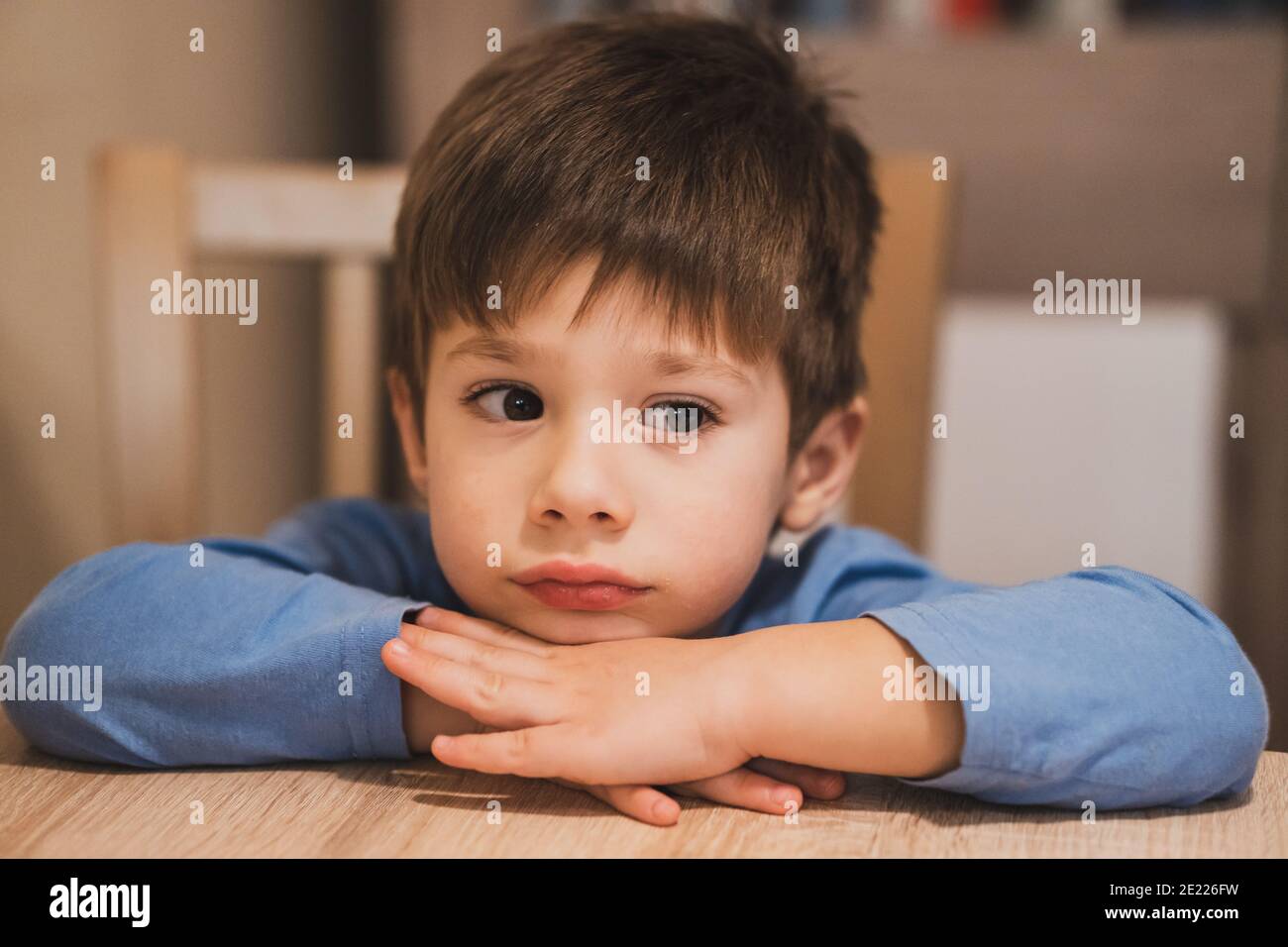 Boy leaning on wooden table hi-res stock photography and images - Alamy