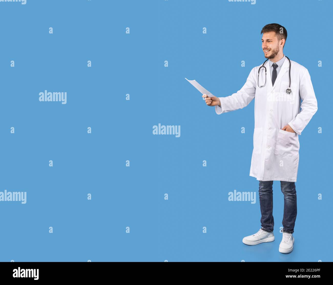 Smiling Male Doctor Recommending Medical Treatment Standing Over Blue ...