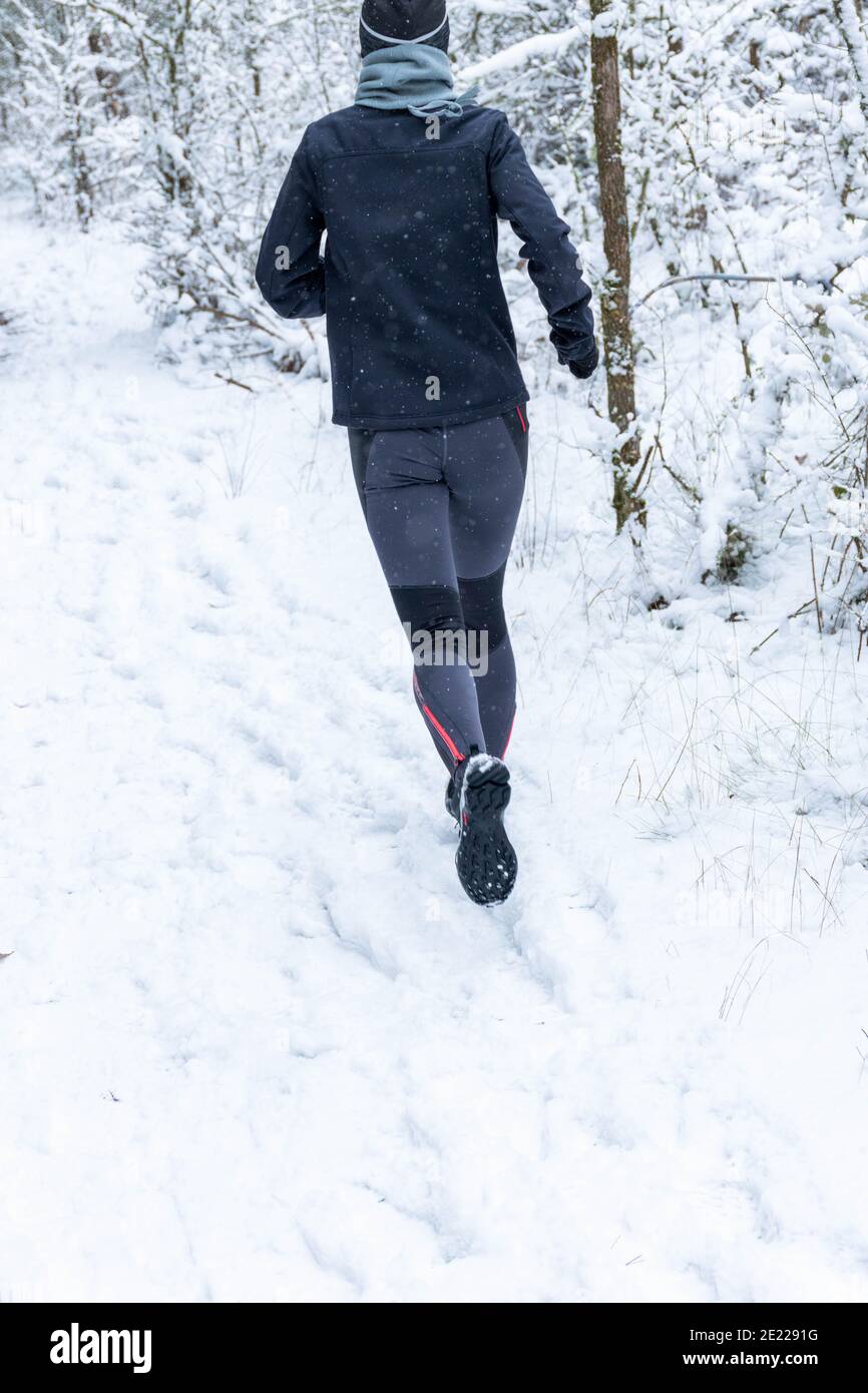 Adult running through snow hi-res stock photography and images - Alamy