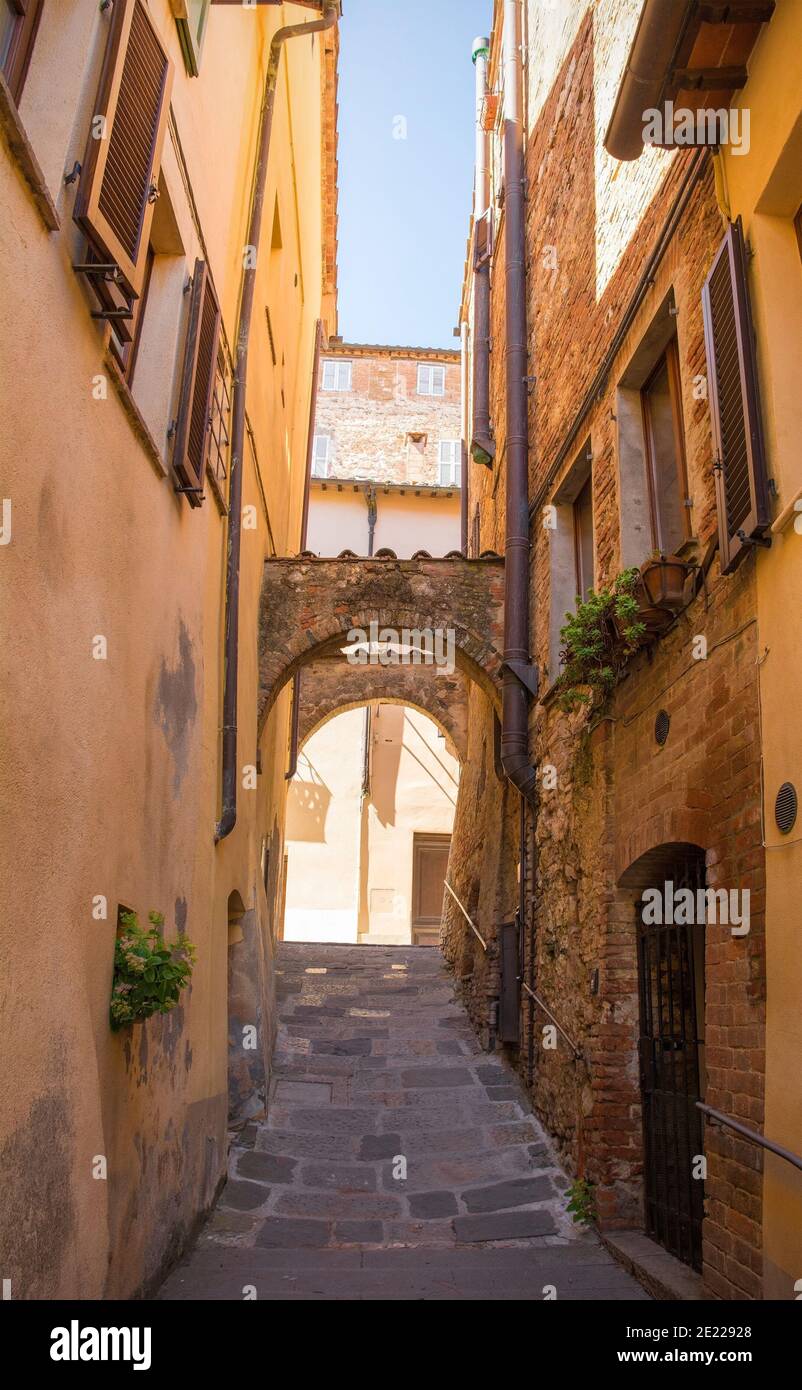 An alley in the historic medieval town of Montepulciano in Siena ...